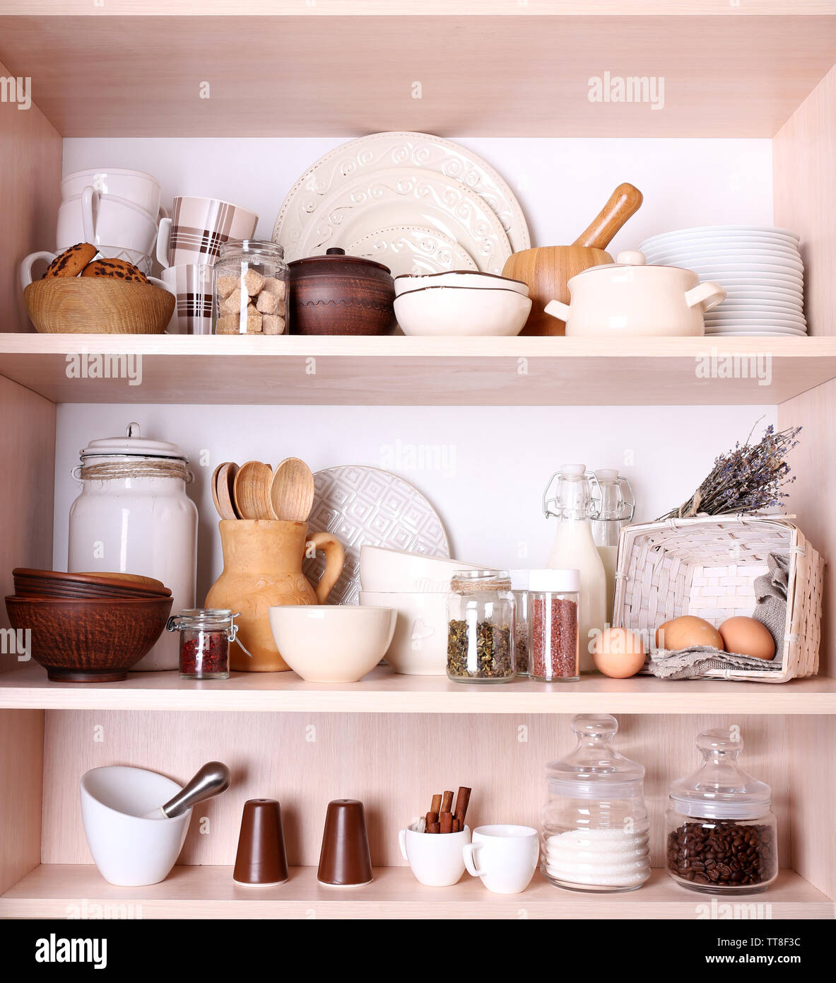 Kitchen utensils and tableware on shelves Stock Photo - Alamy