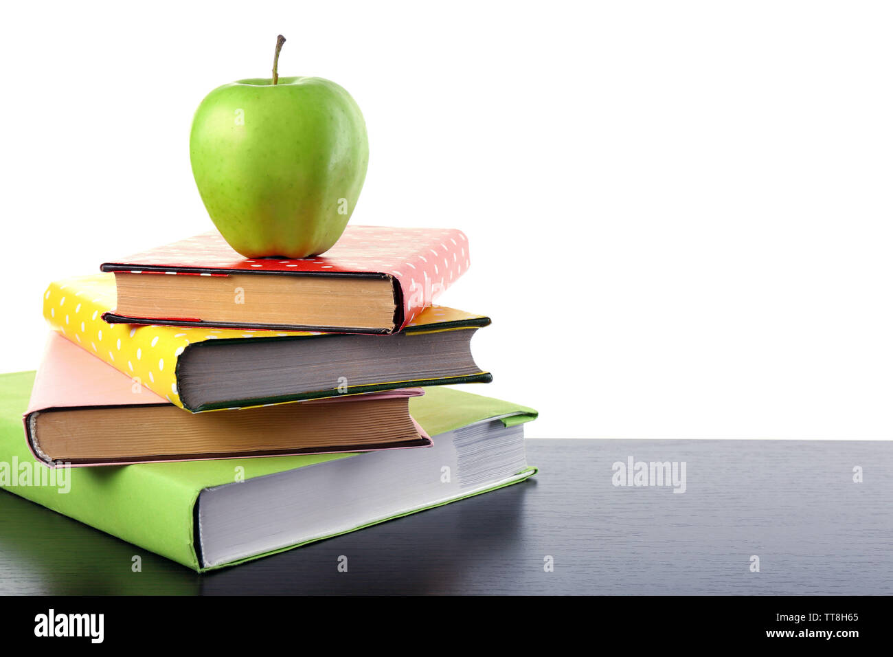Books and apple on desk, isolated on white Stock Photo - Alamy