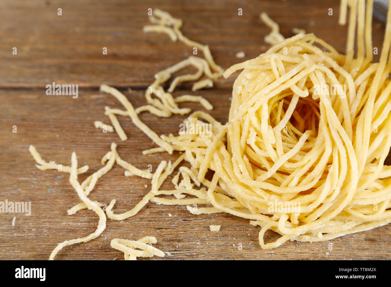 Homemade vermicelli on wooden background Stock Photo - Alamy