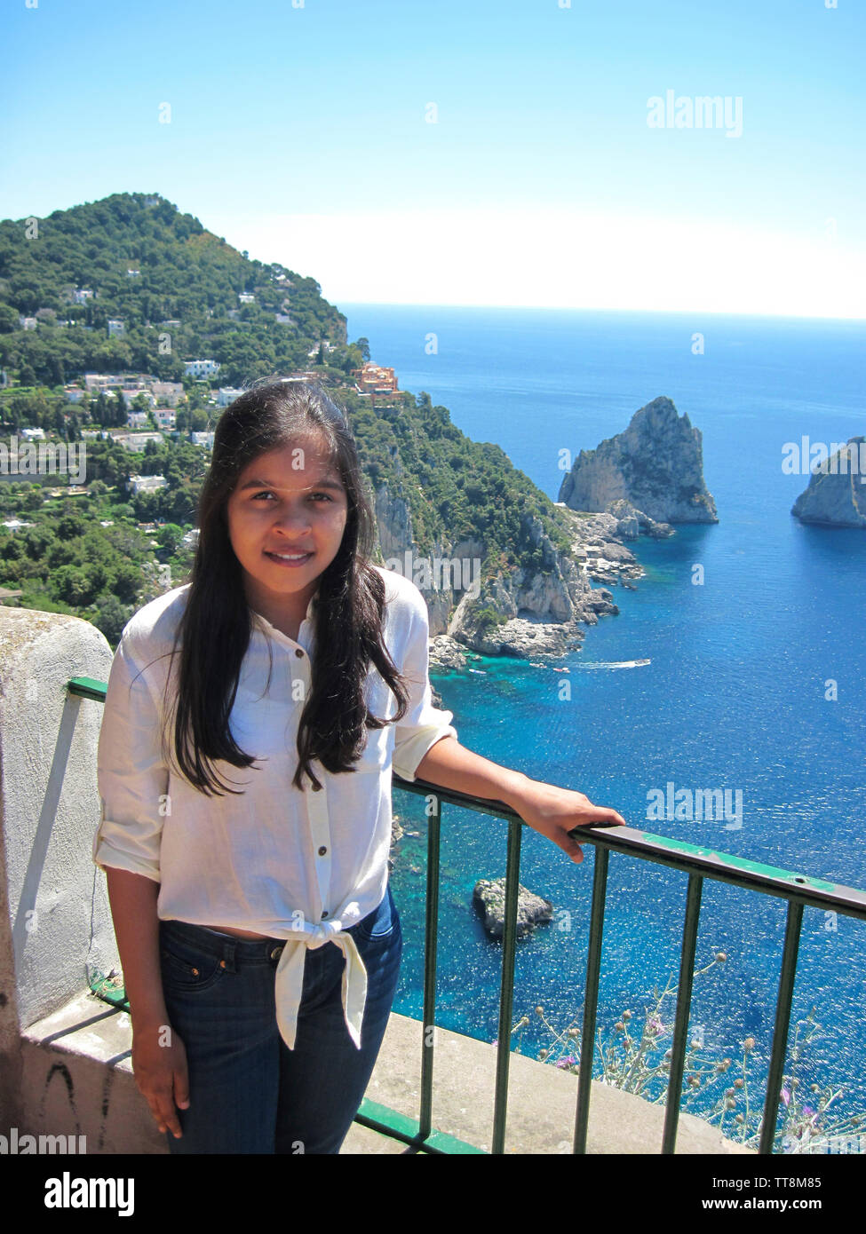 PORTRAIT OF A YOUNG GIRL. WITH A PANAROMIC VIEW OF CAPRI ISLAND WITH ...