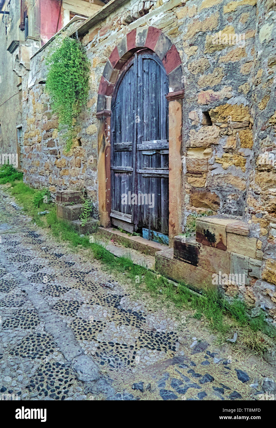 Kambos area, chios island, Greece, rustic arched wooden door on stone ...