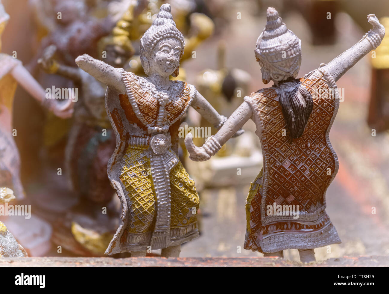 Two small,dancing statues of an old Buddhism shrine Stock Photo - Alamy