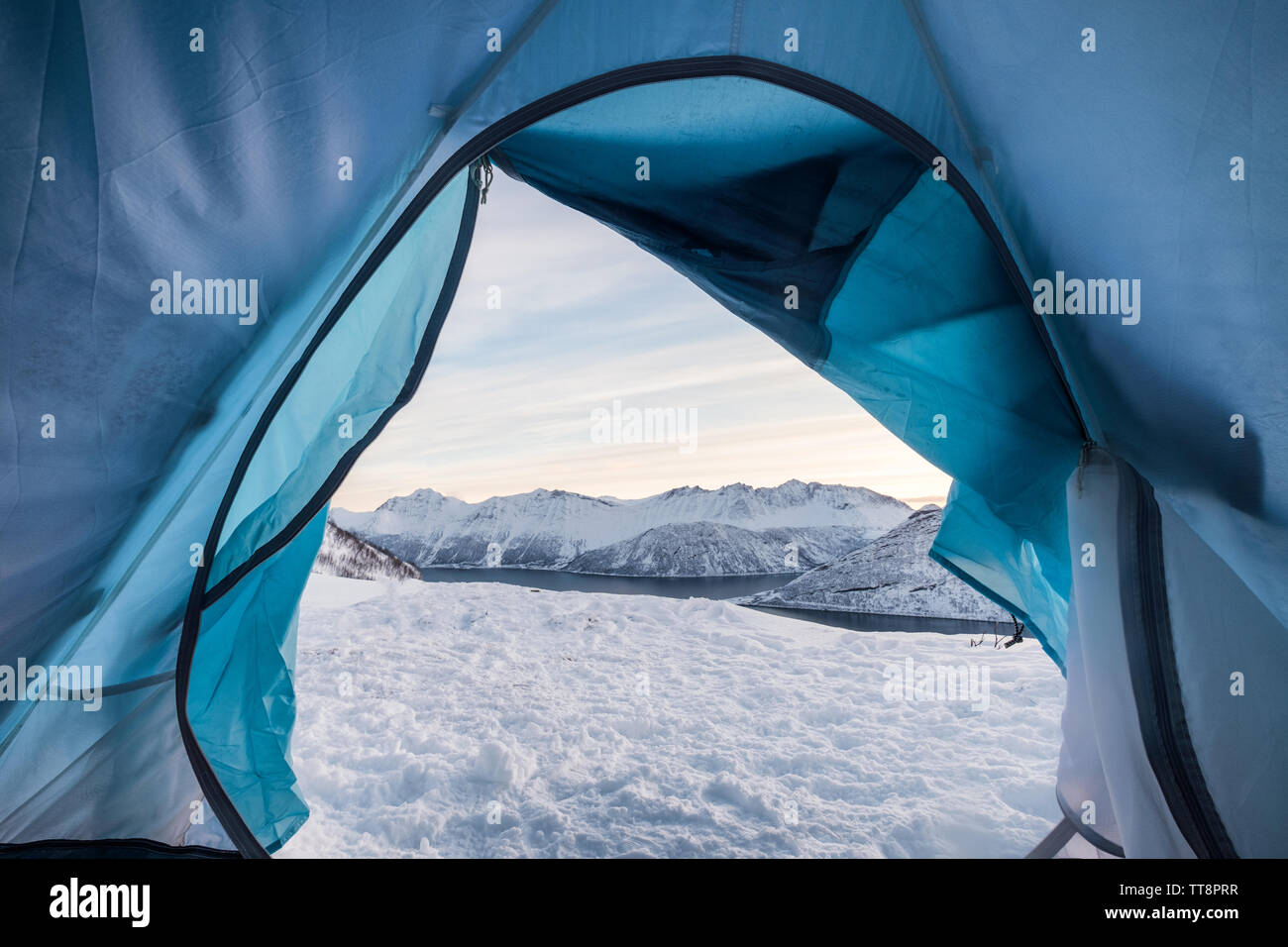 Relaxing inside tent camping opening with snowy mountain on peak Stock ...