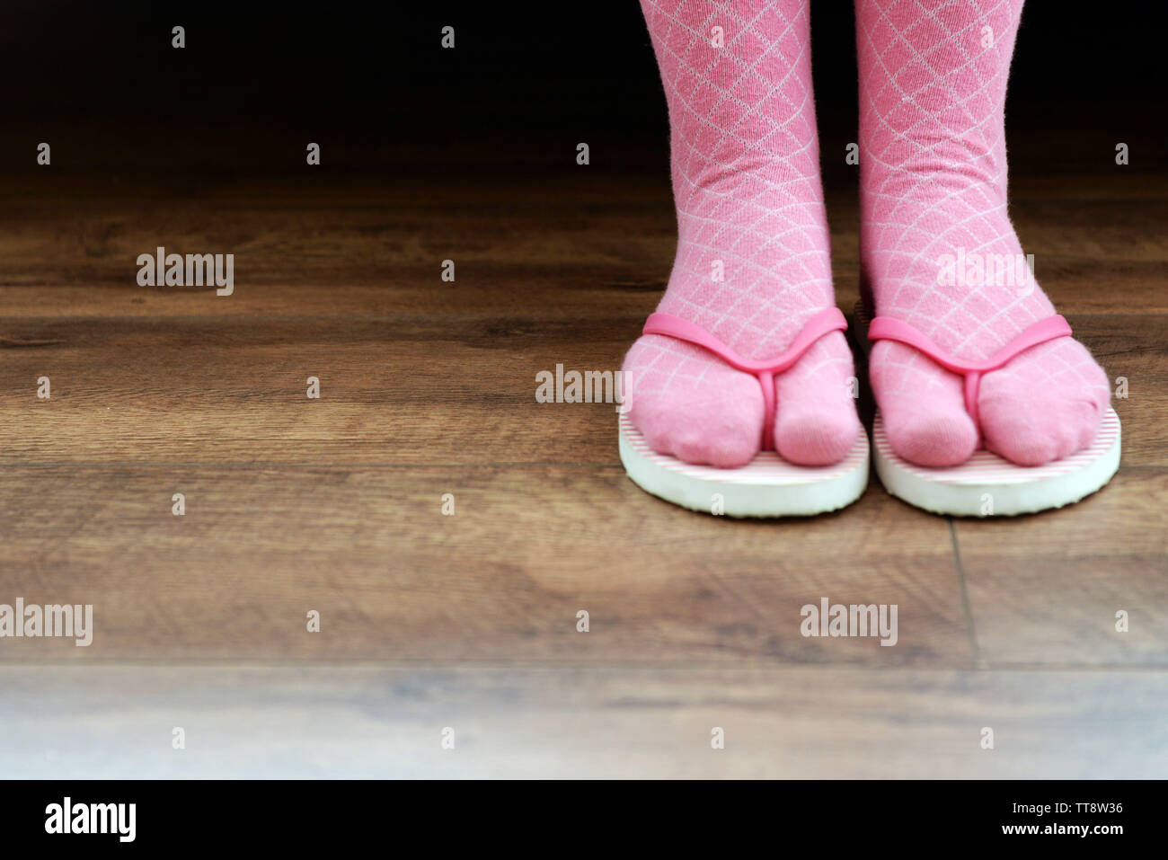 Female feet in socks with pink flip-flops, on floor background Stock ...