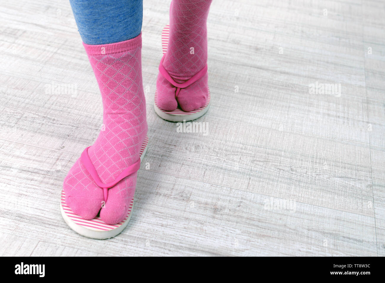 Female feet in socks with pink flip-flops, on floor background Stock ...