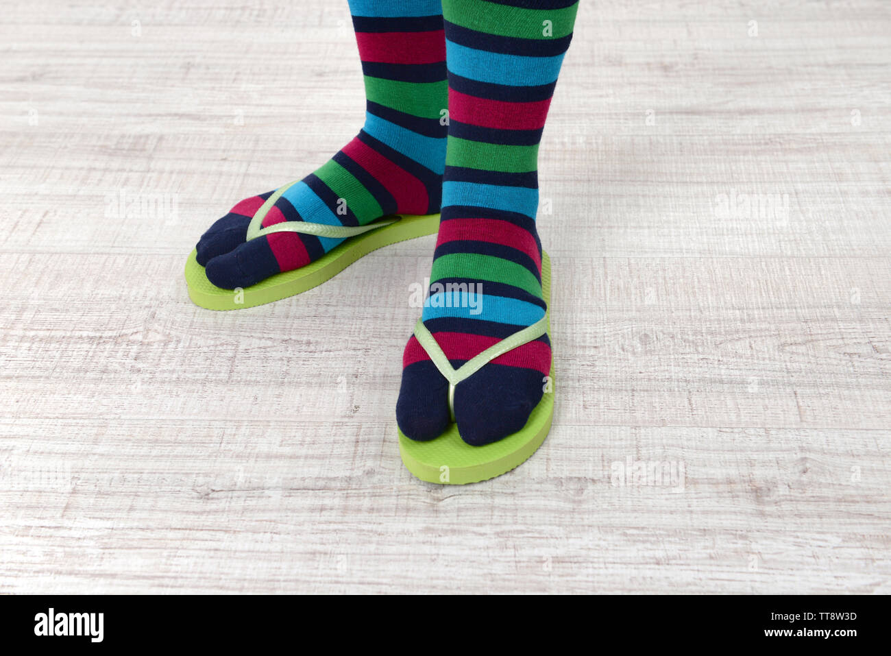 Female feet in socks with pink flip-flops, on floor background Stock ...