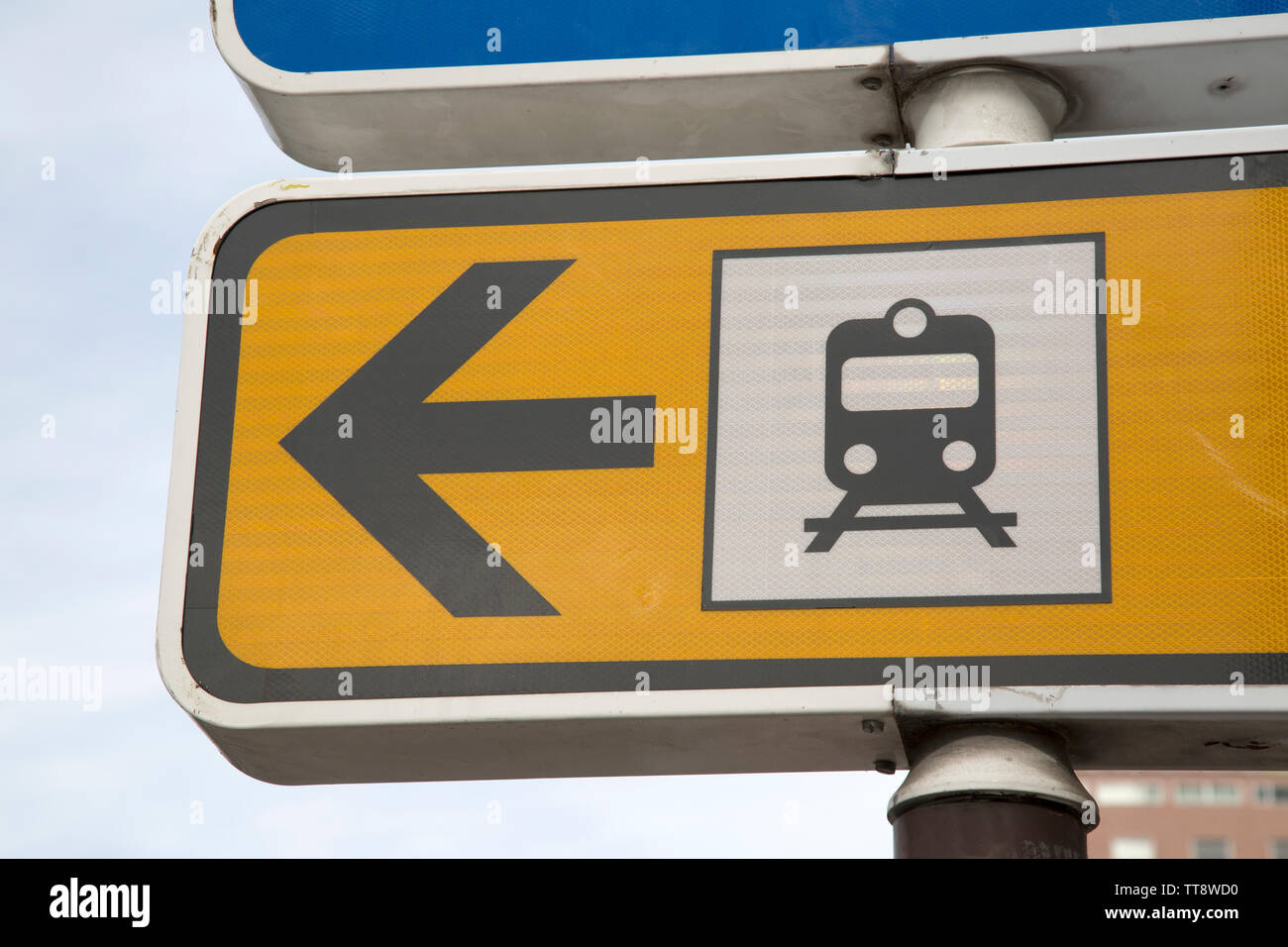 Yellow Railroad Station Sign with Arrow Stock Photo - Alamy