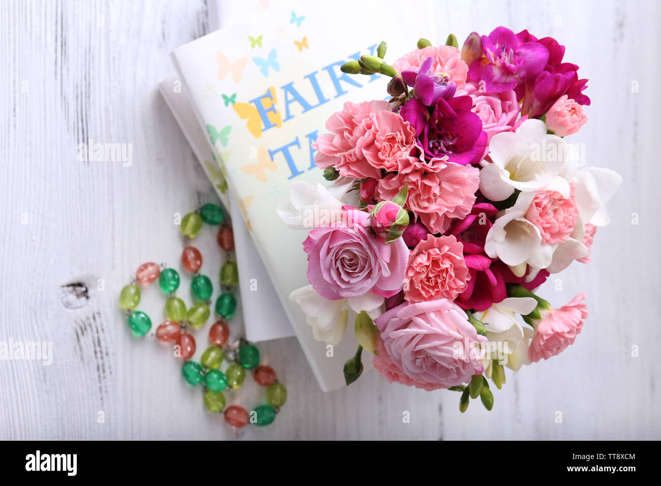 Beautiful fresh spring flowers with stack of books, top view Stock ...