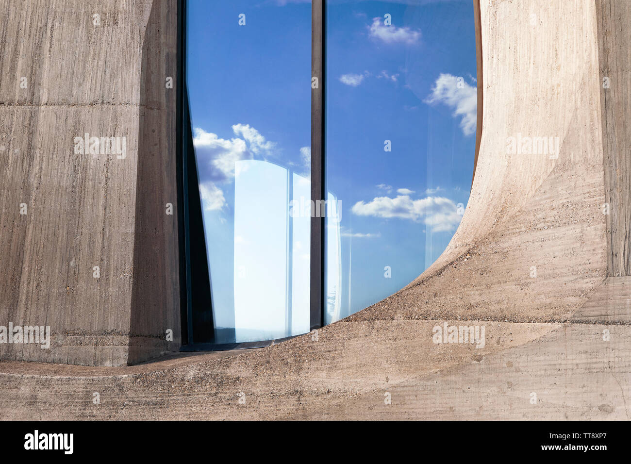 Fancy window with blue sky and clouds reflecting in glass. Modern ...