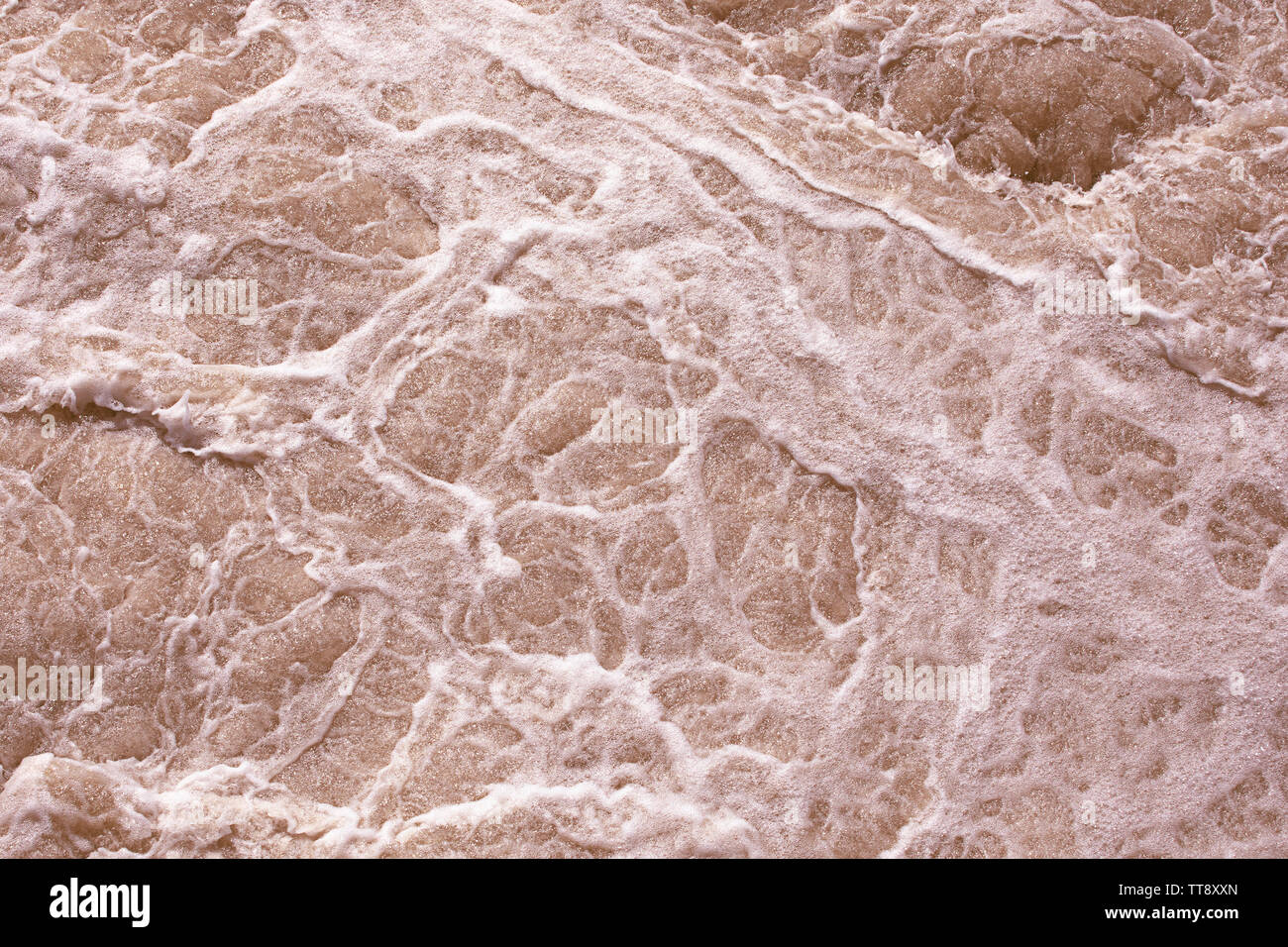 Abstract background, rough water surface. Foaming pink water. Foam and ...