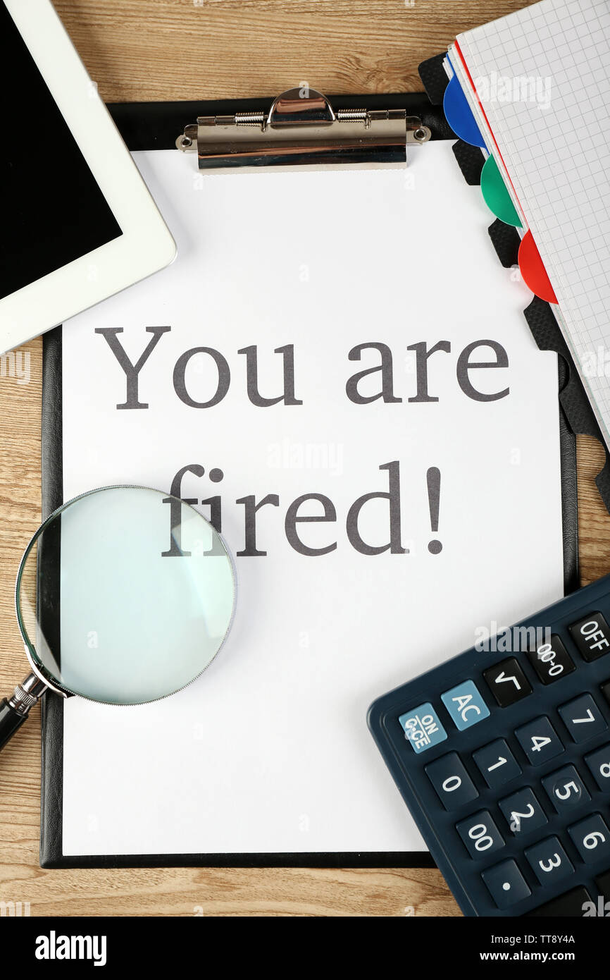 Message You're Fired on clipboard on wooden table, closeup Stock Photo ...