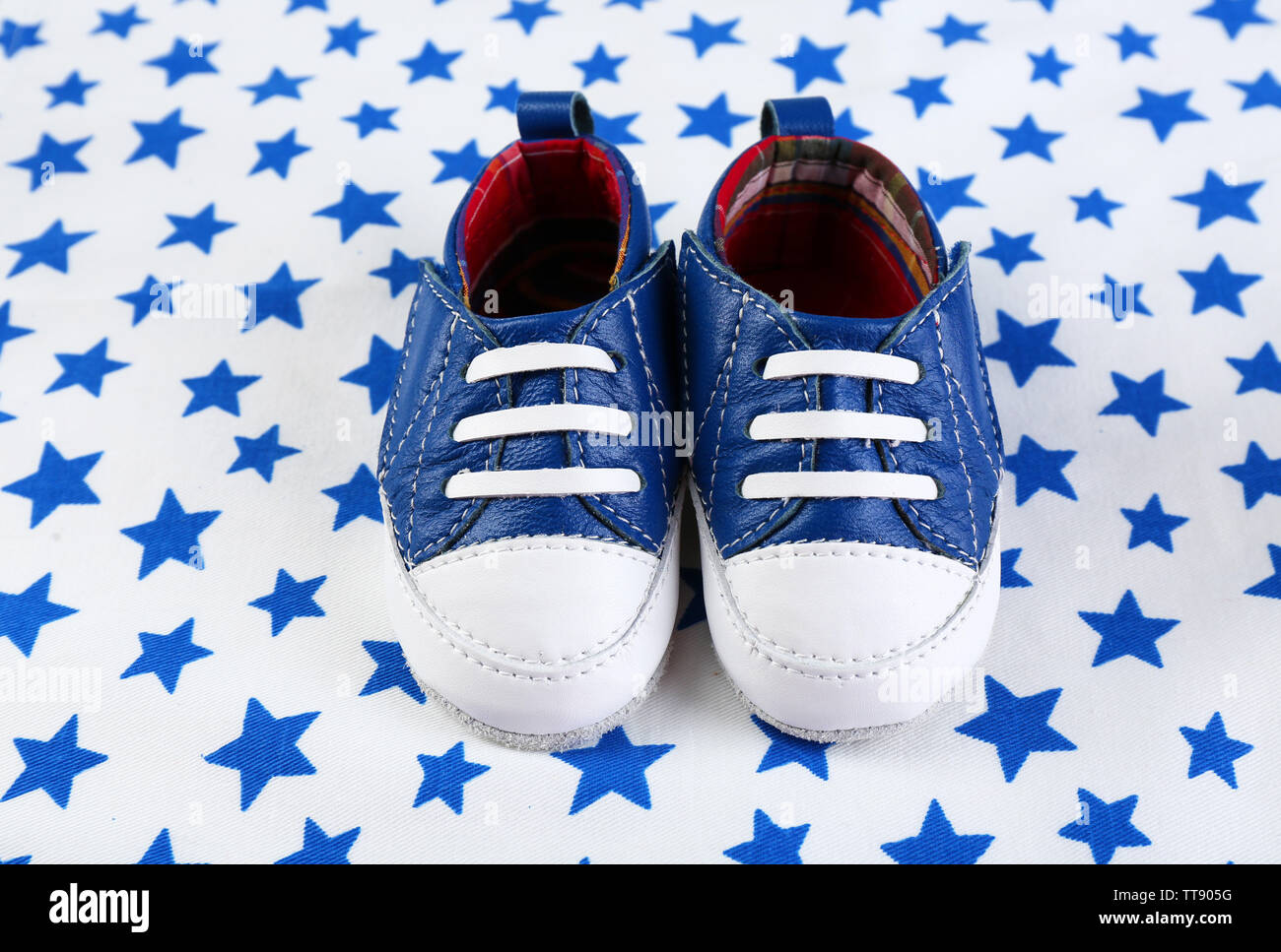 Baby shoes on cloth background Stock Photo - Alamy