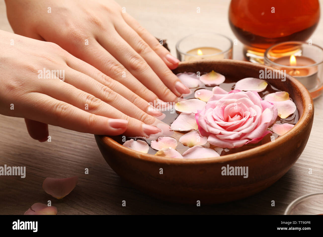 Female hands and bowl of spa water with flowers, closeup Stock Photo ...