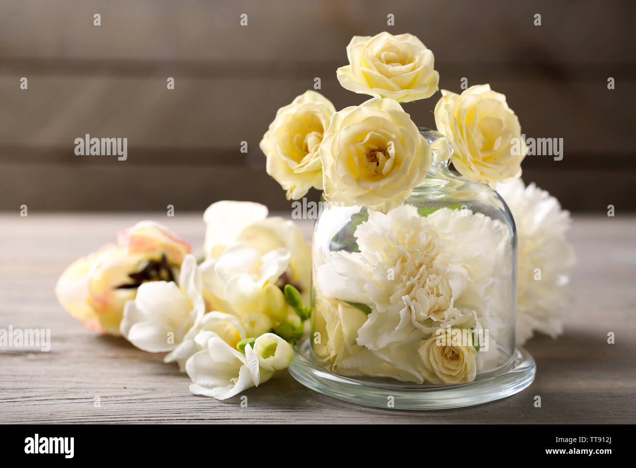 Beautiful composition with flowers on grey wooden background Stock ...