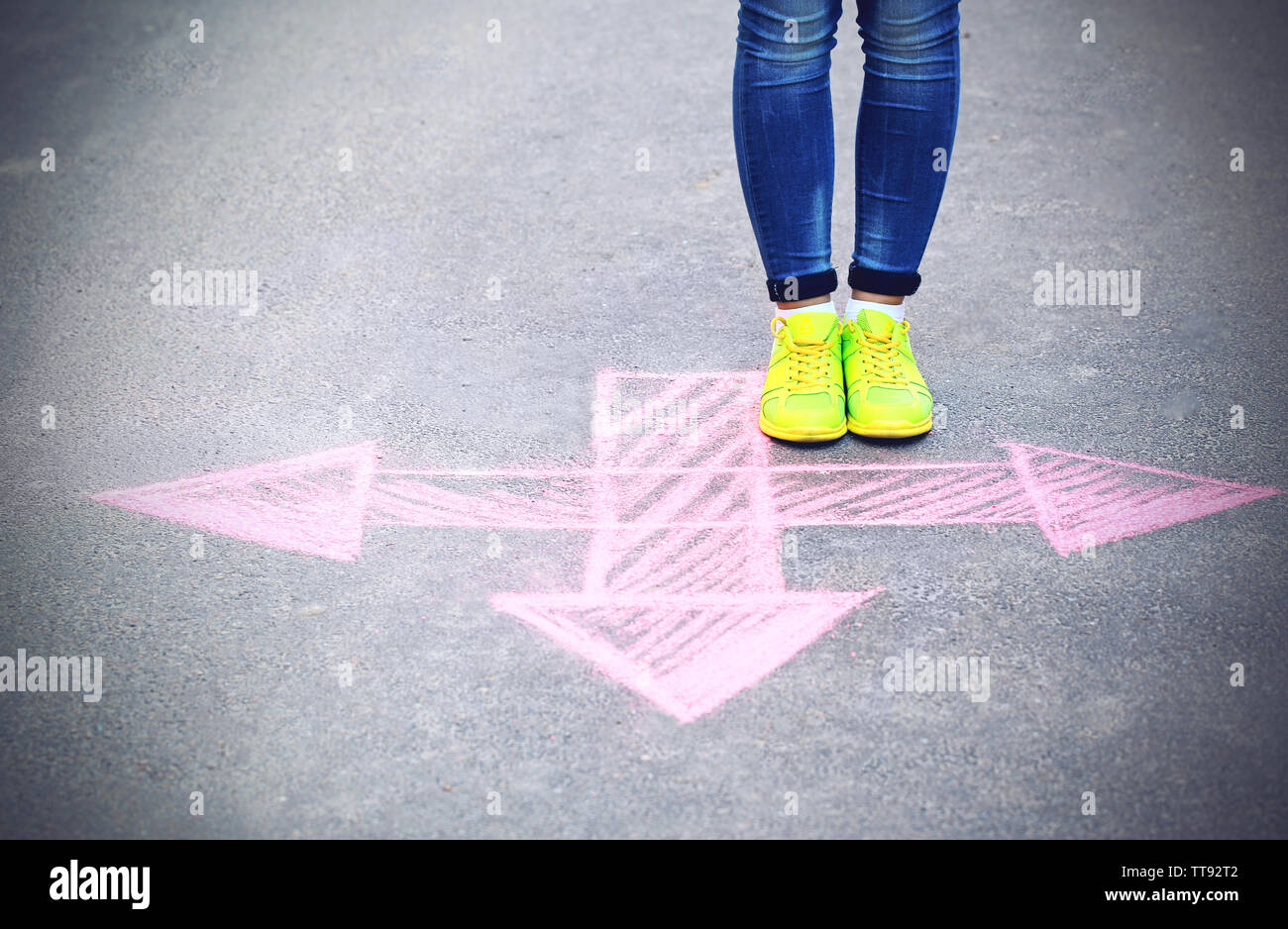 Female feet and drawing arrows on pavement background Stock Photo - Alamy