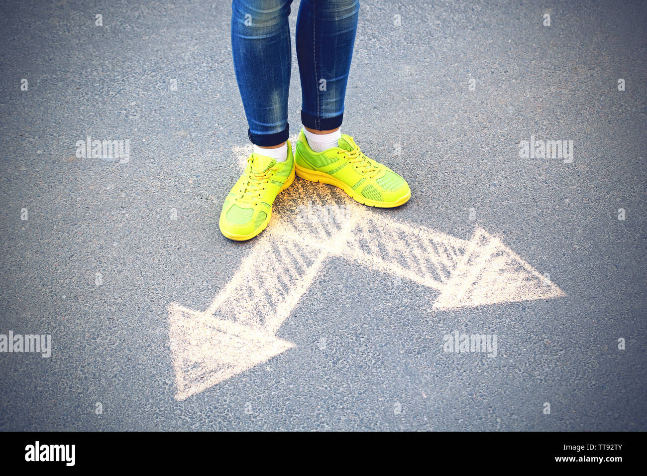 Female feet and drawing arrows on pavement background Stock Photo - Alamy
