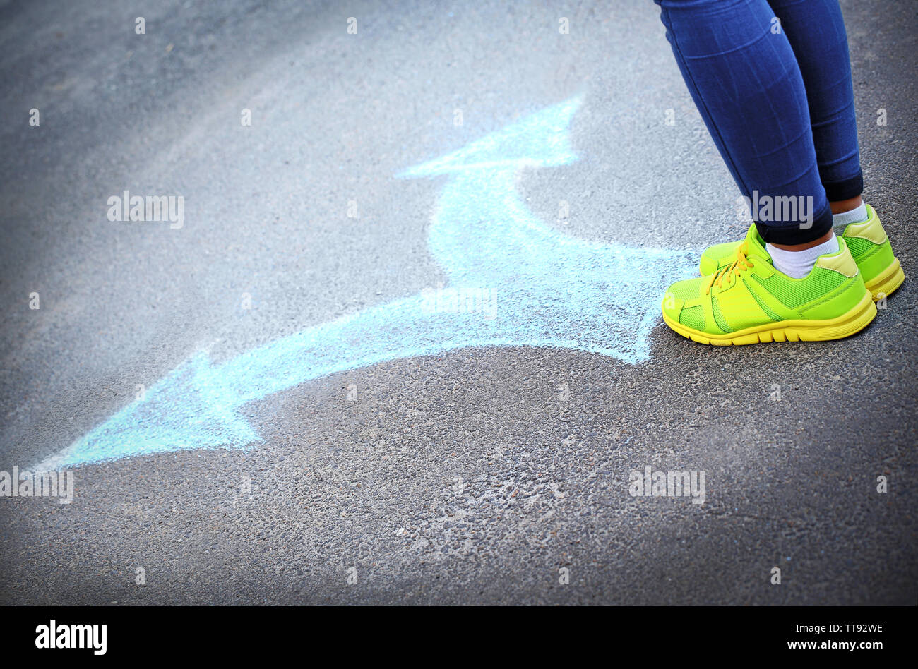 Female feet and drawing arrows on pavement background Stock Photo - Alamy