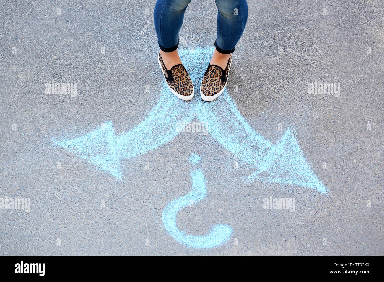 Female feet and drawing arrows on pavement background Stock Photo - Alamy