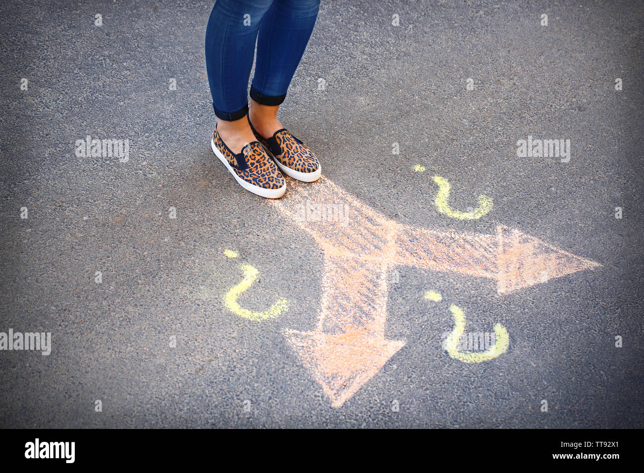 Female feet and drawing arrows on pavement background Stock Photo - Alamy