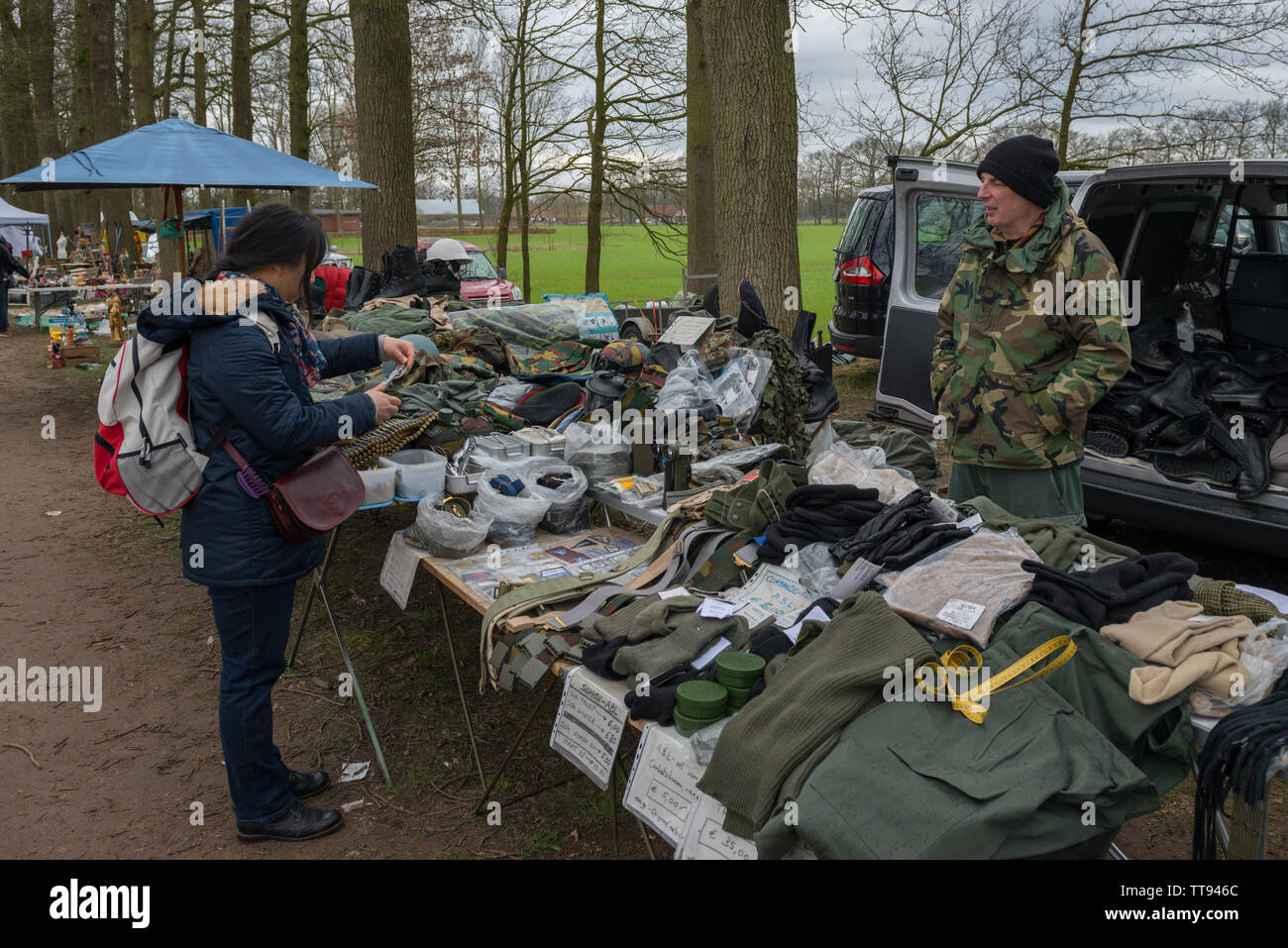 Man selling army goods and clothing on a market stall Stock Photo - Alamy