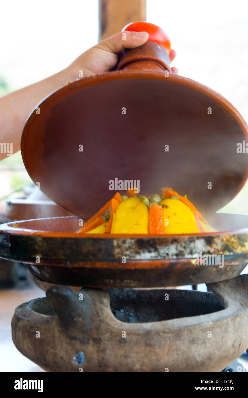 cooking in traditional moroccan tajine pot over open fire Stock Photo ...