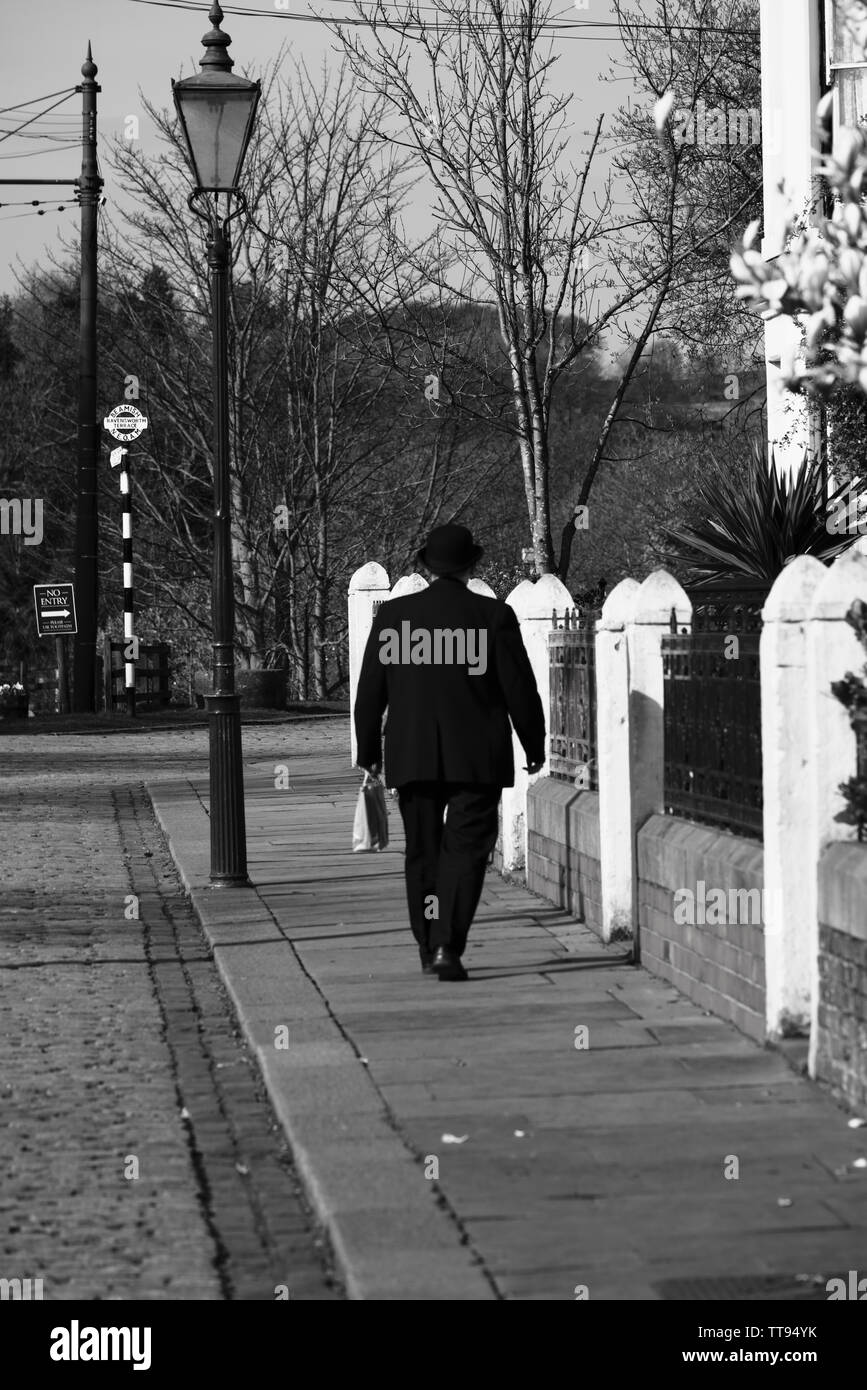 Gentleman Walking Down a Street - Black & White Stock Photo - Alamy
