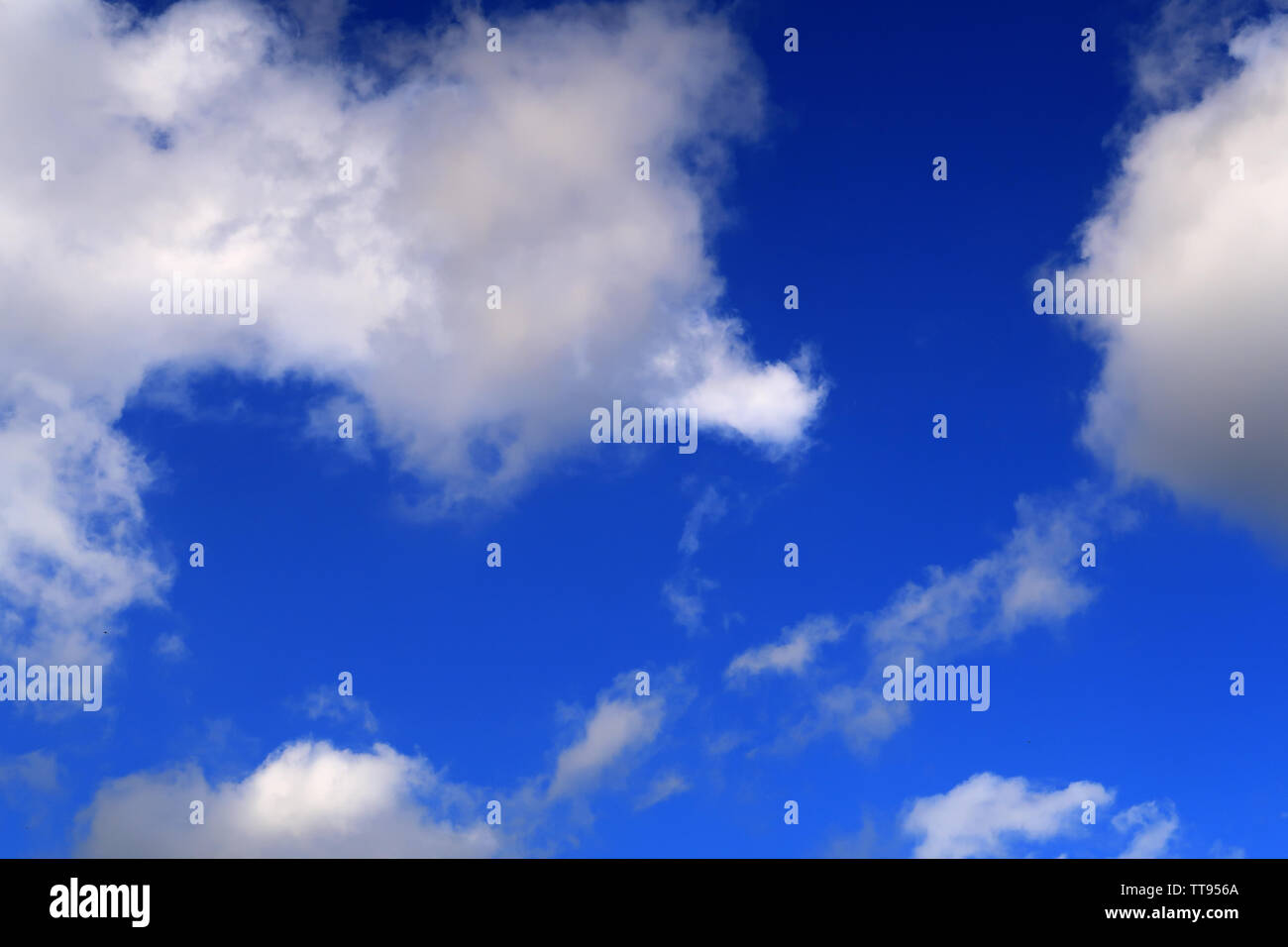 Cloud filled deep blue sky Stock Photo - Alamy