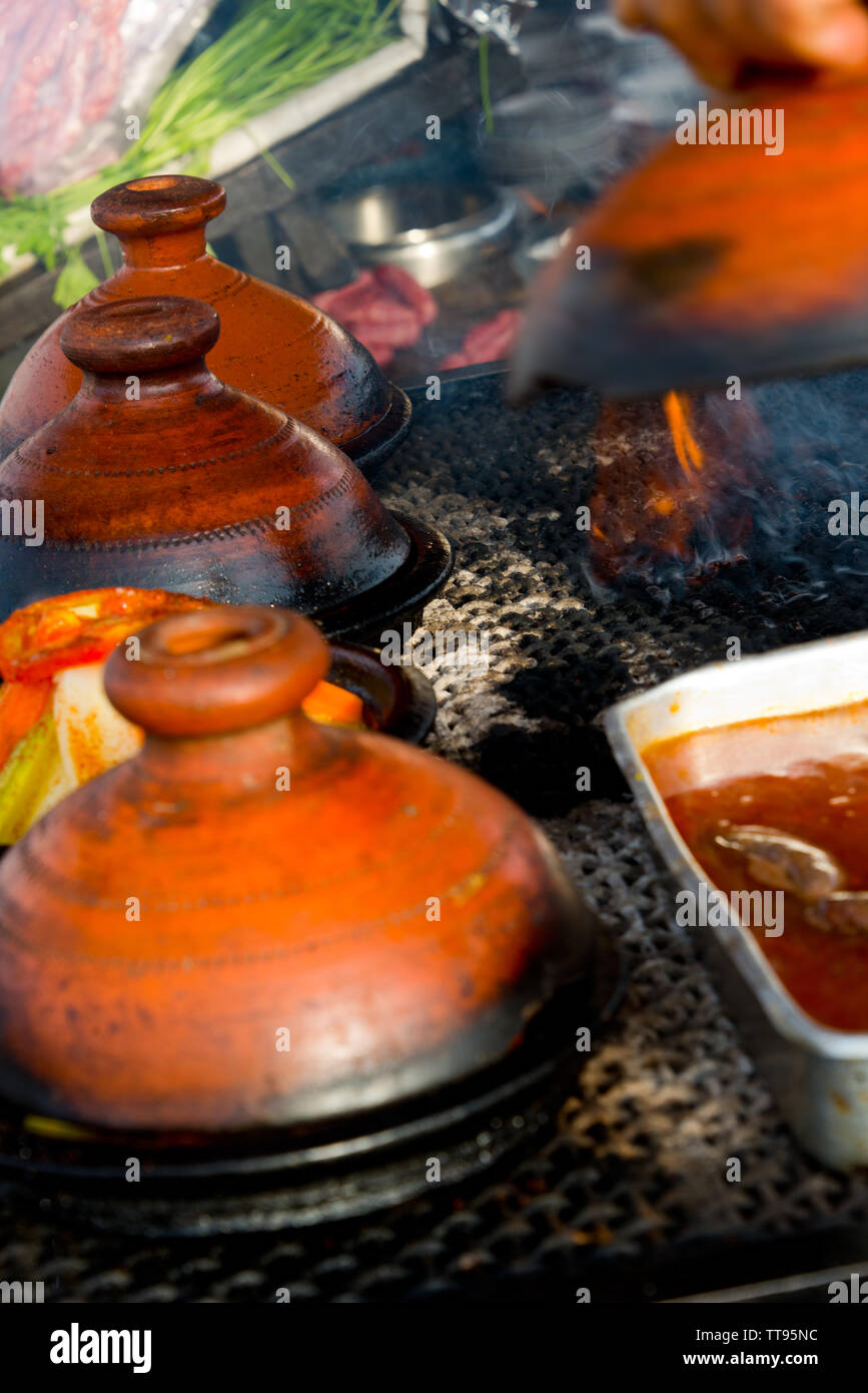 cooking in traditional moroccan tajine pot over open fire Stock Photo ...