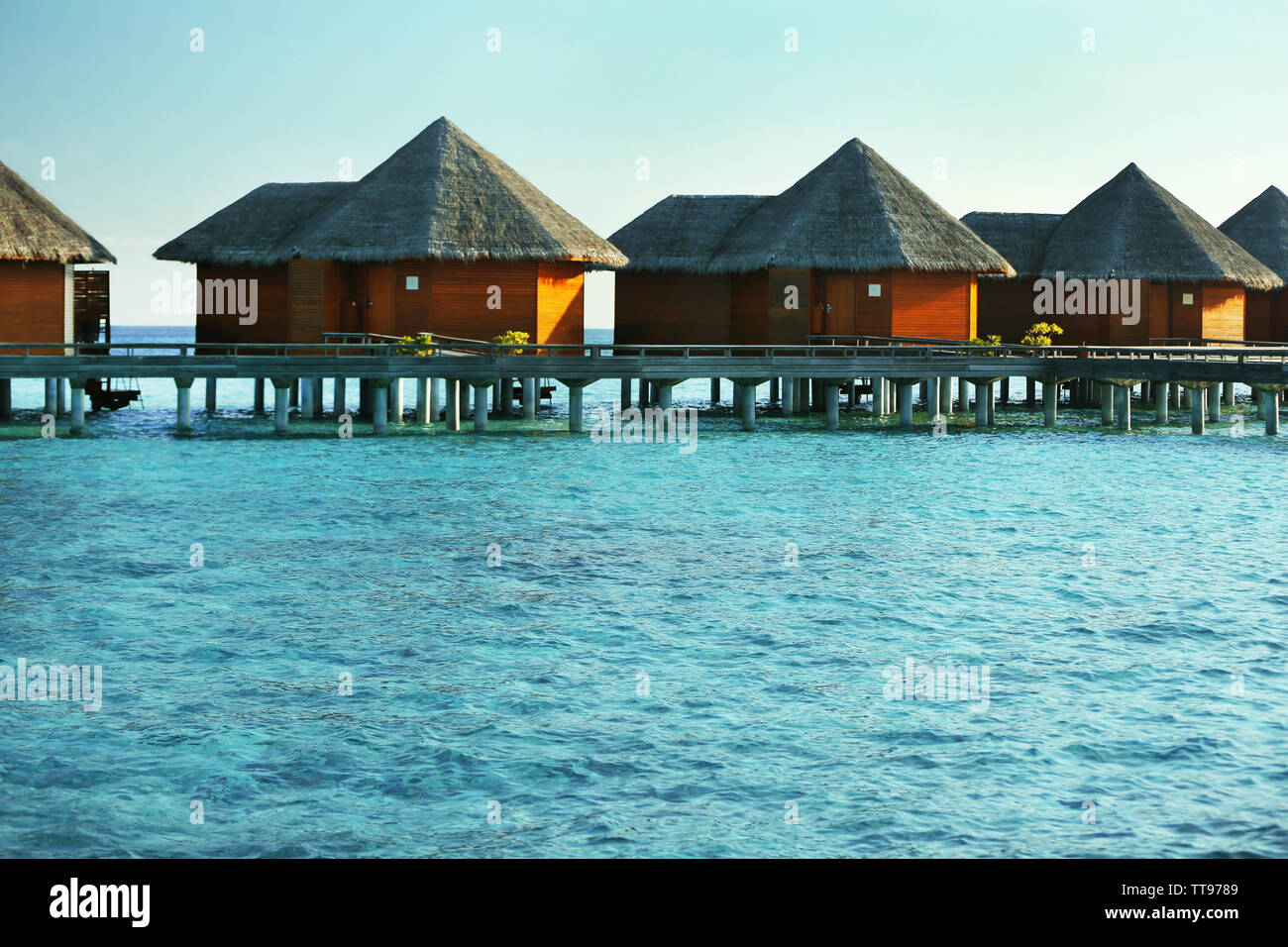 Water villas over ocean background, in resort Stock Photo - Alamy