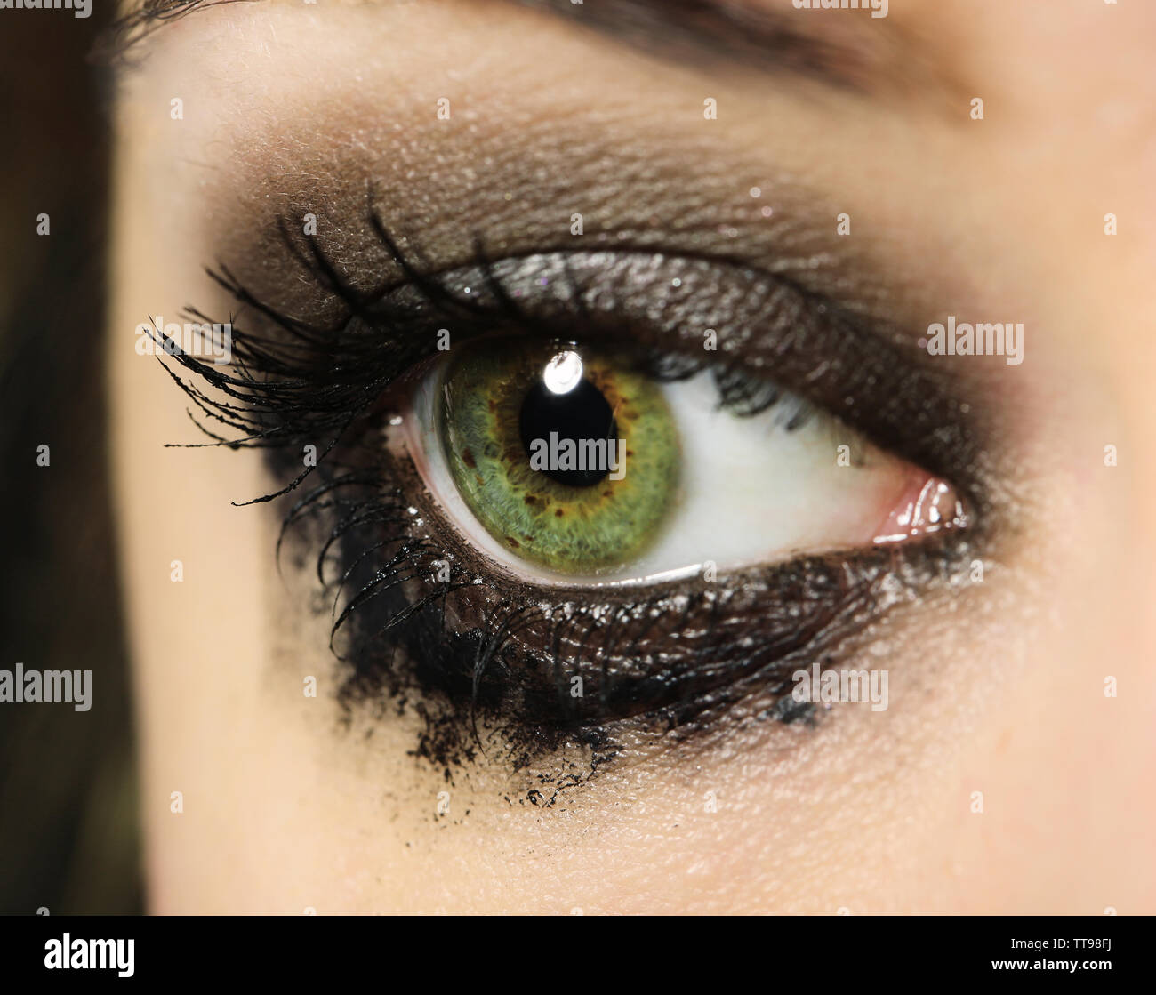 Eye of young woman with tear drop close up Stock Photo - Alamy
