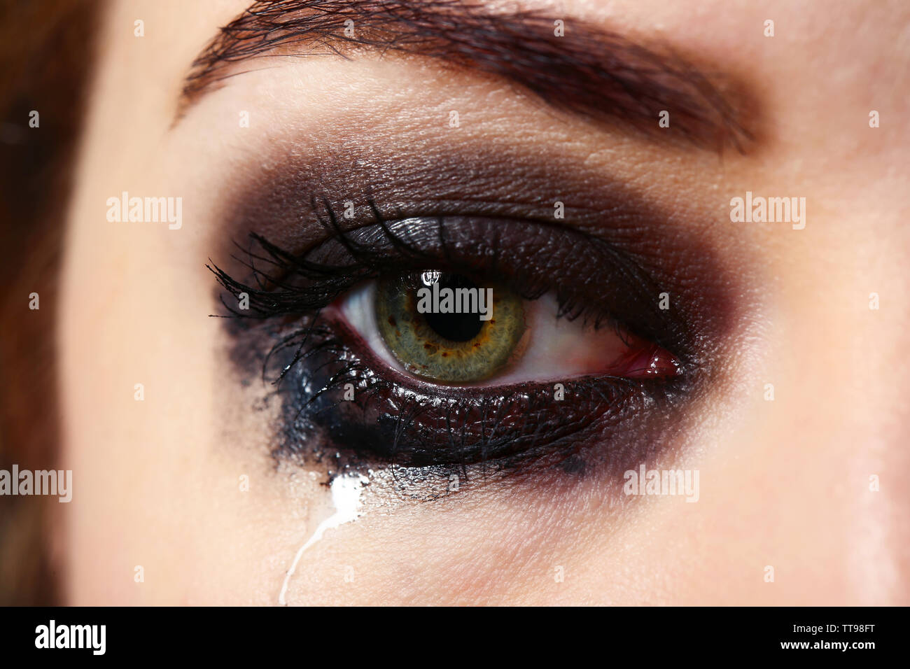 Eye of young woman with tear drop close up Stock Photo - Alamy