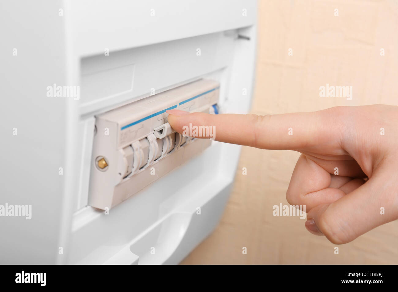 Woman turning off fuse box close up Stock Photo - Alamy