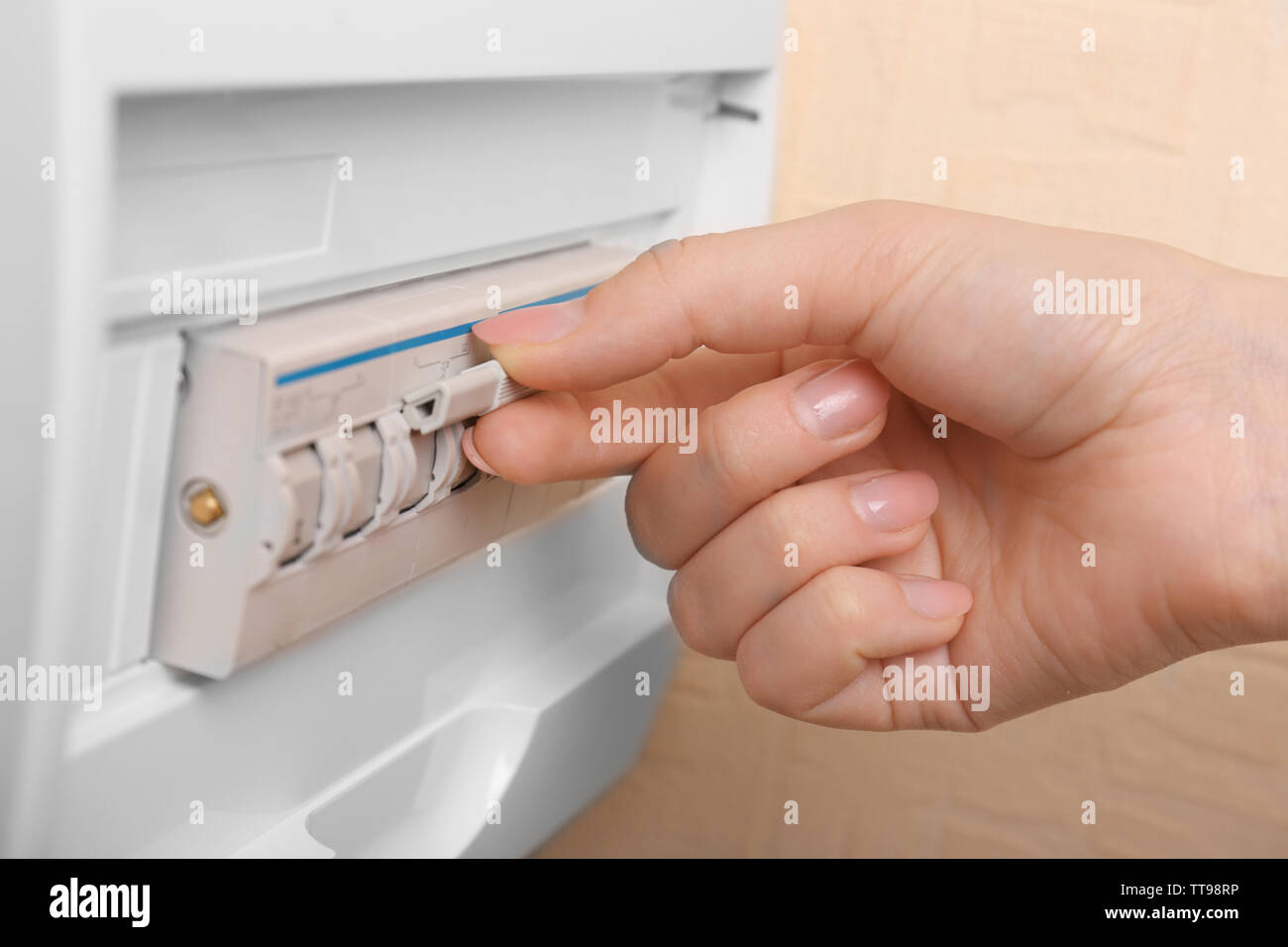 Woman turning off fuse box close up Stock Photo - Alamy