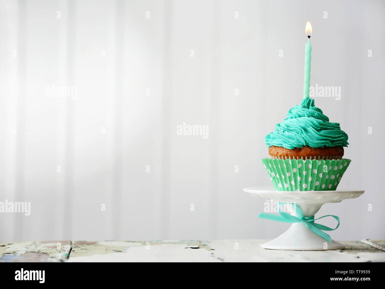 Delicious birthday cupcake on light background Stock Photo - Alamy