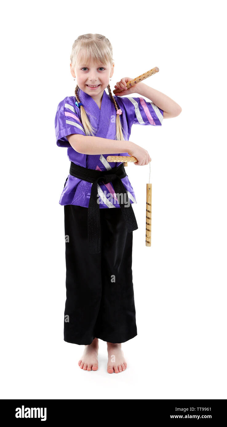 Little girl in kimono doing exercises with nunchaku isolated on white ...