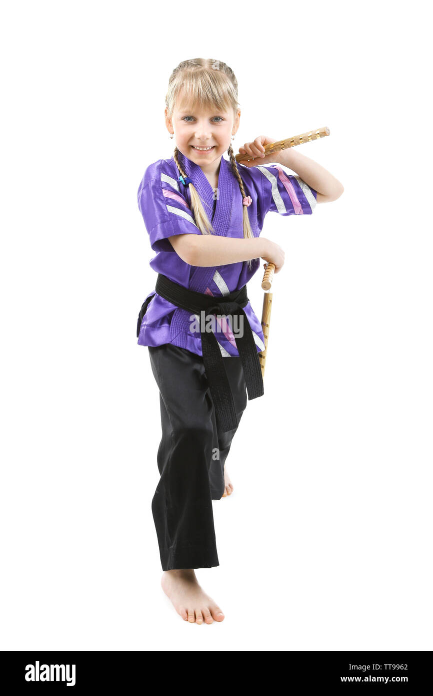 Little girl in kimono doing exercises with nunchaku isolated on white ...
