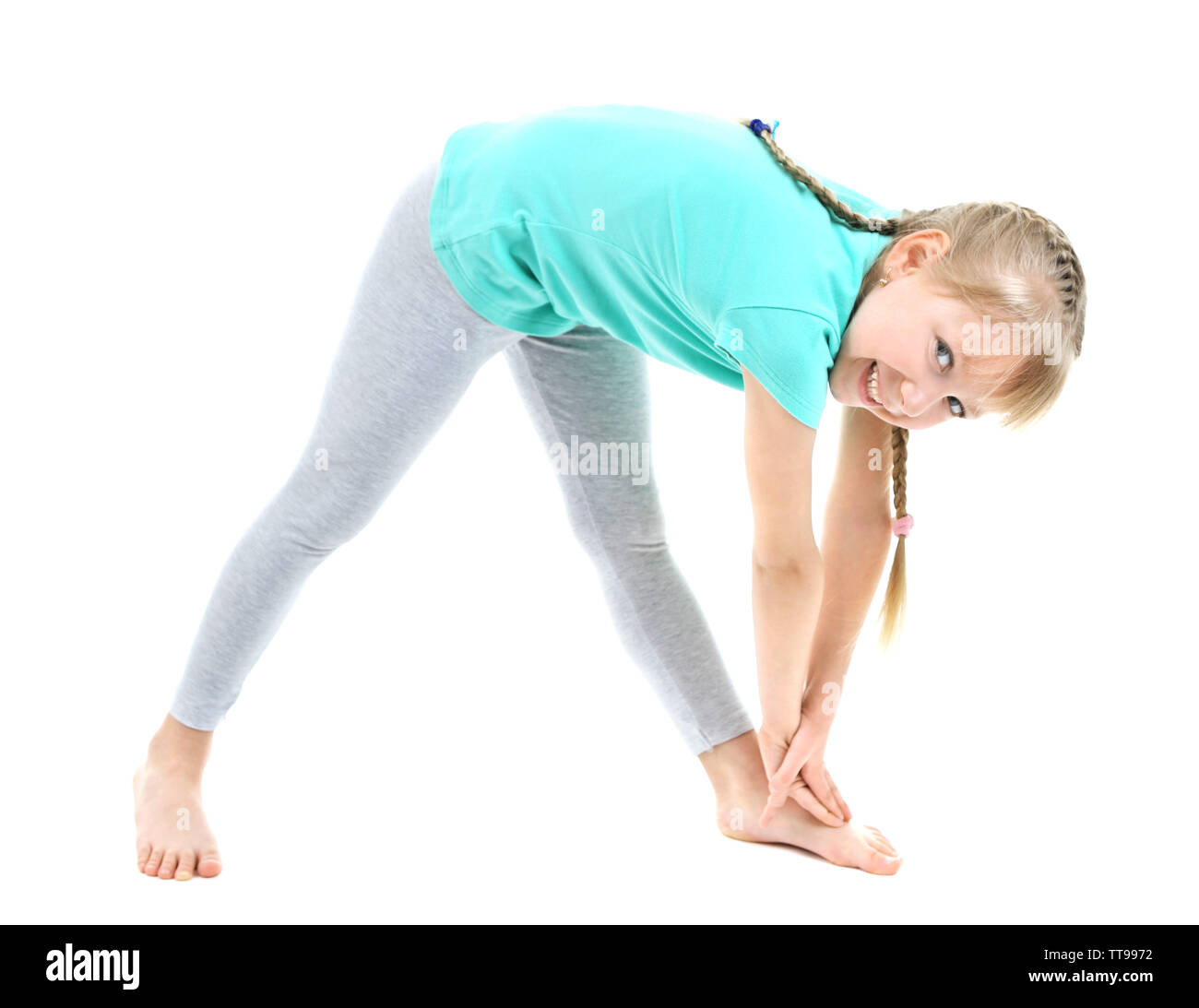 Little girl doing exercises isolated on white Stock Photo - Alamy
