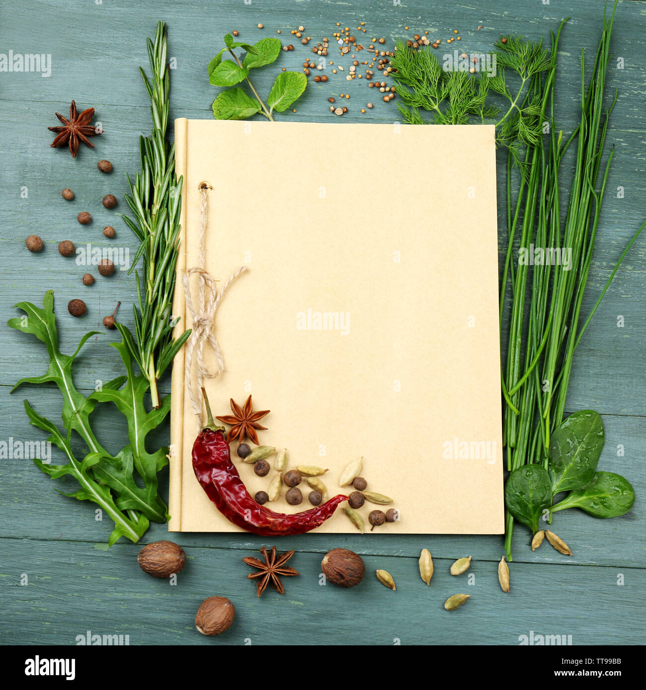 Open recipe book with fresh herbs and spices on wooden background Stock ...