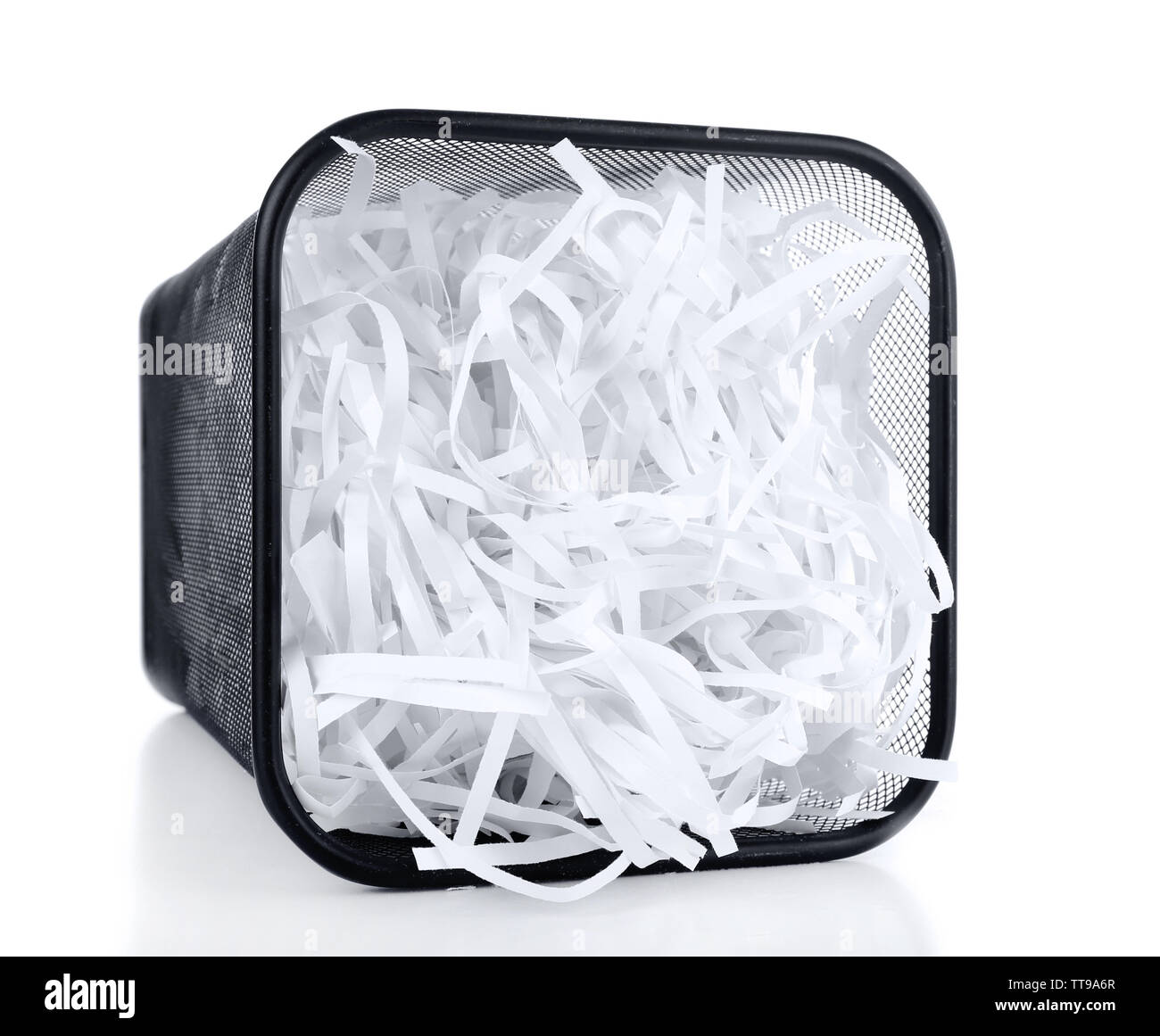 Strips of destroyed paper from shredder in trash can isolated on white ...