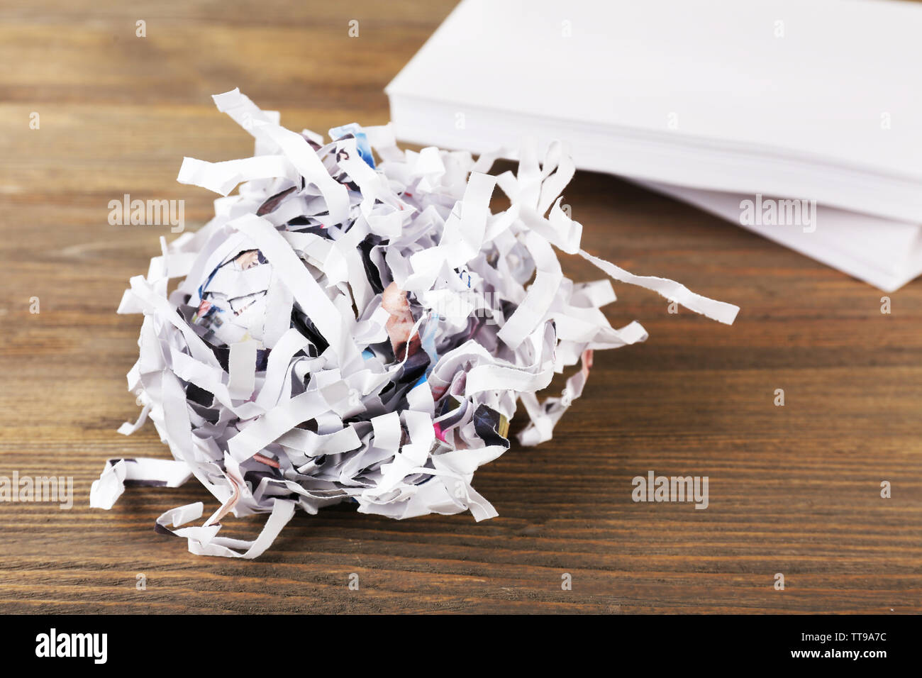 Strips of destroyed paper from shredder on wooden background Stock ...