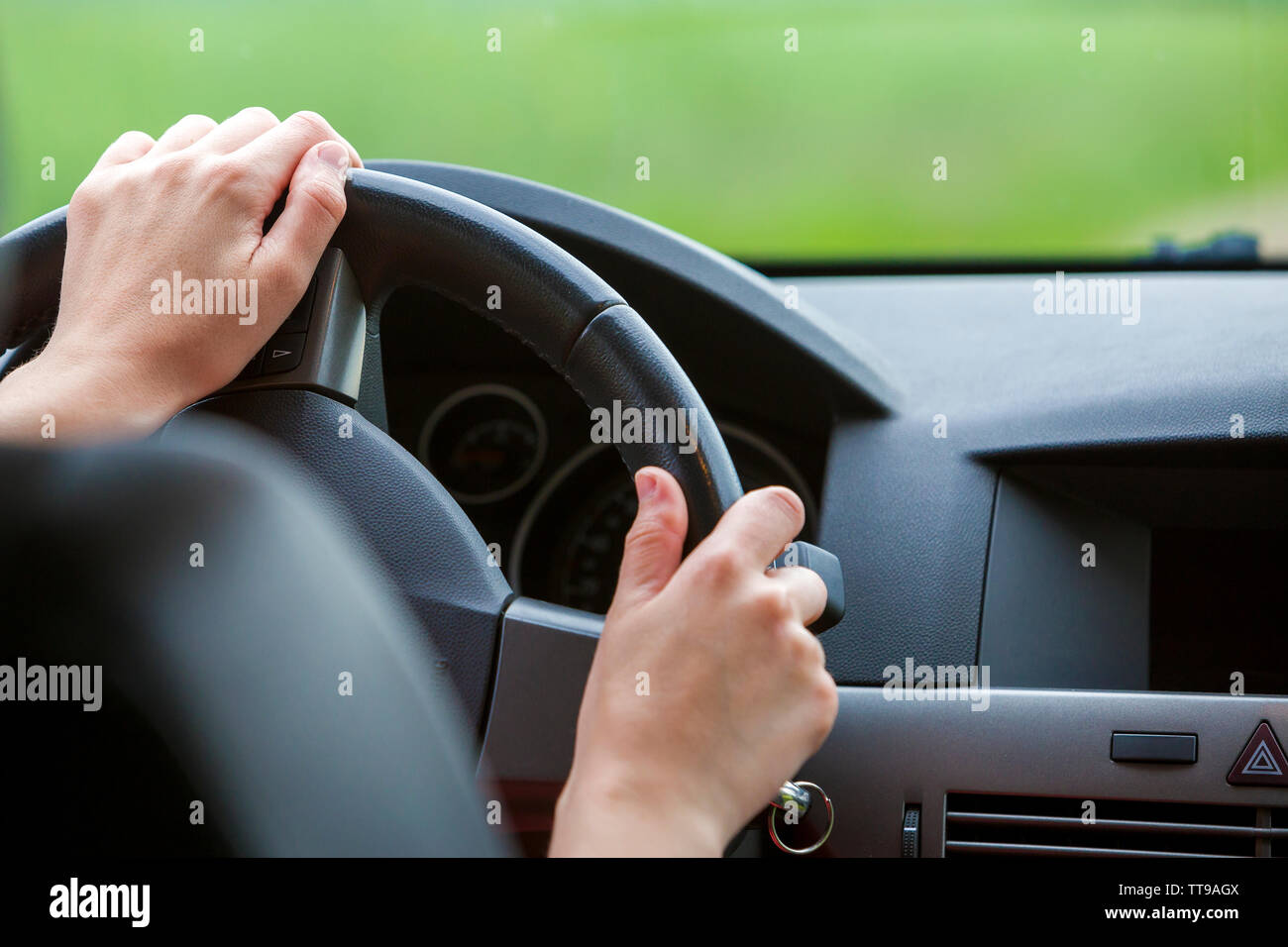 Woman hands on steering wheel driving a car Stock Photo - Alamy