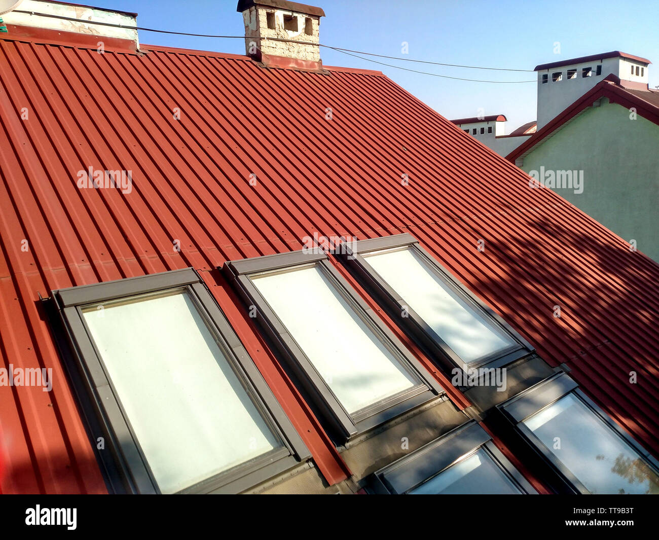 Red tiled house roof with attic windows. Roofing construction, window ...