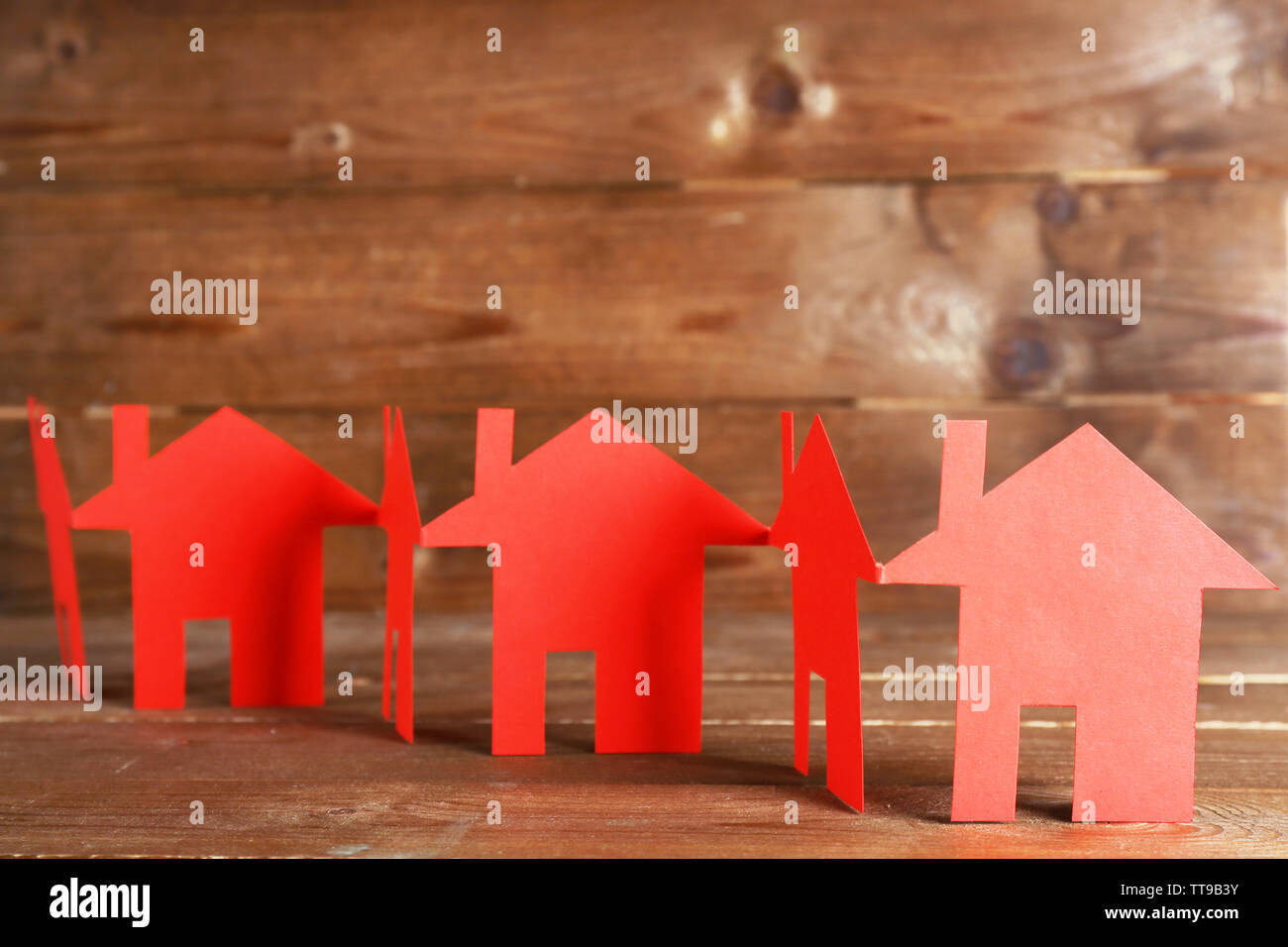 Paper houses on wooden background Stock Photo - Alamy