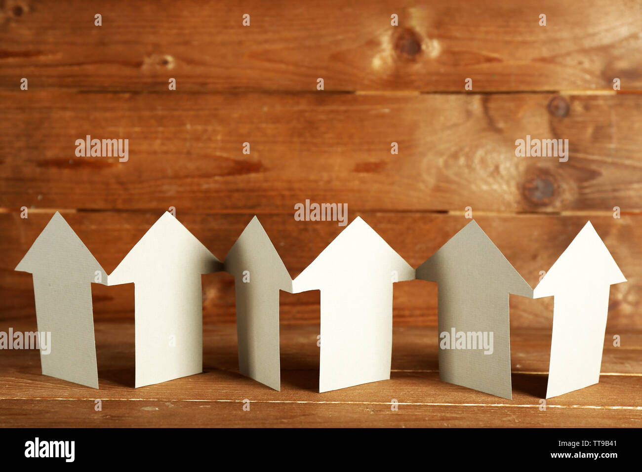 Paper houses on wooden background Stock Photo - Alamy