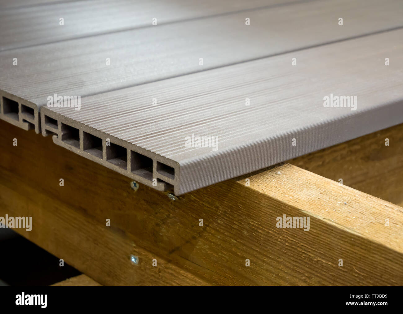 Using modern plastic decking to create a floor Stock Photo - Alamy