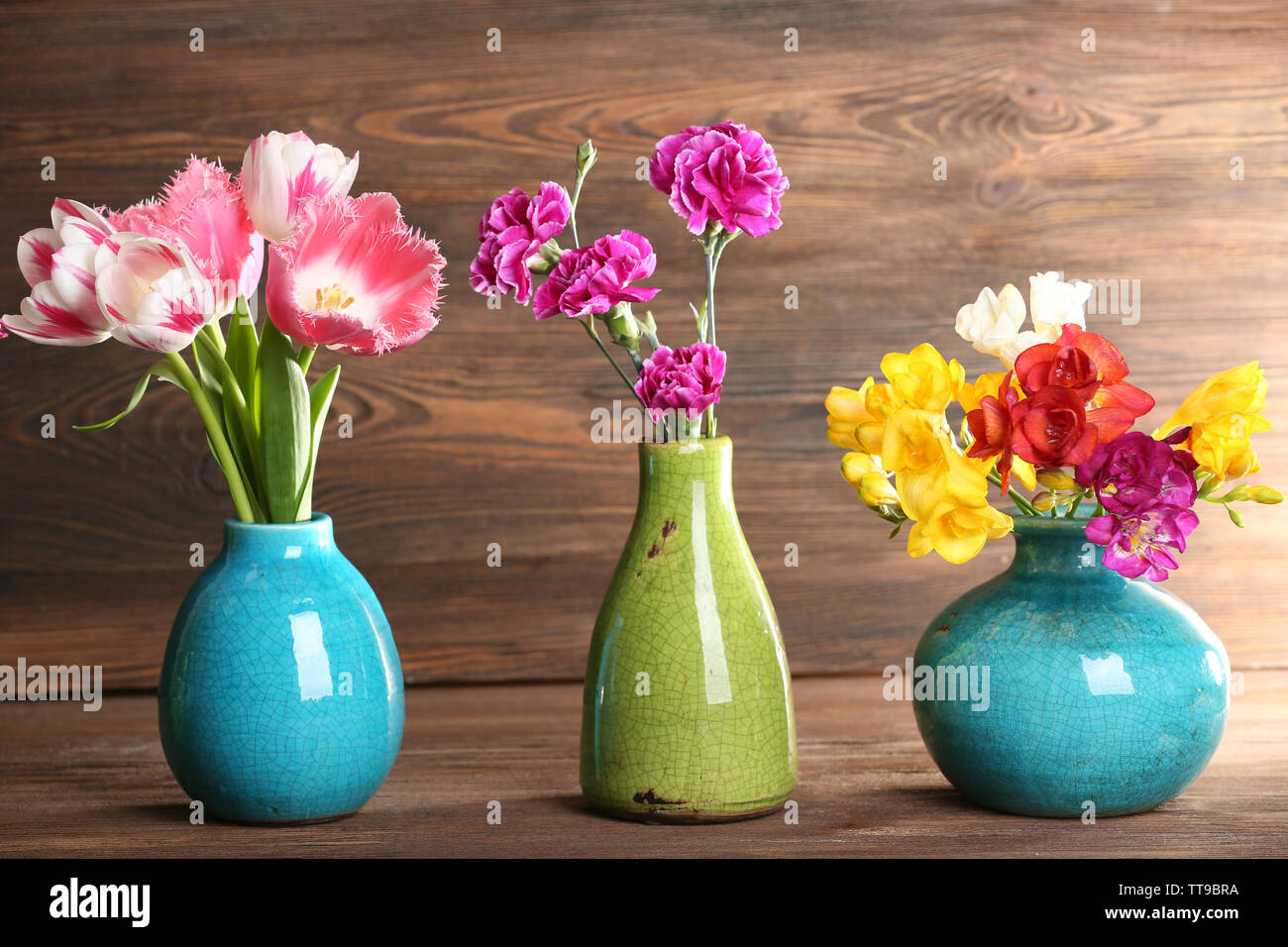 Fresh spring flowers on wooden background Stock Photo - Alamy