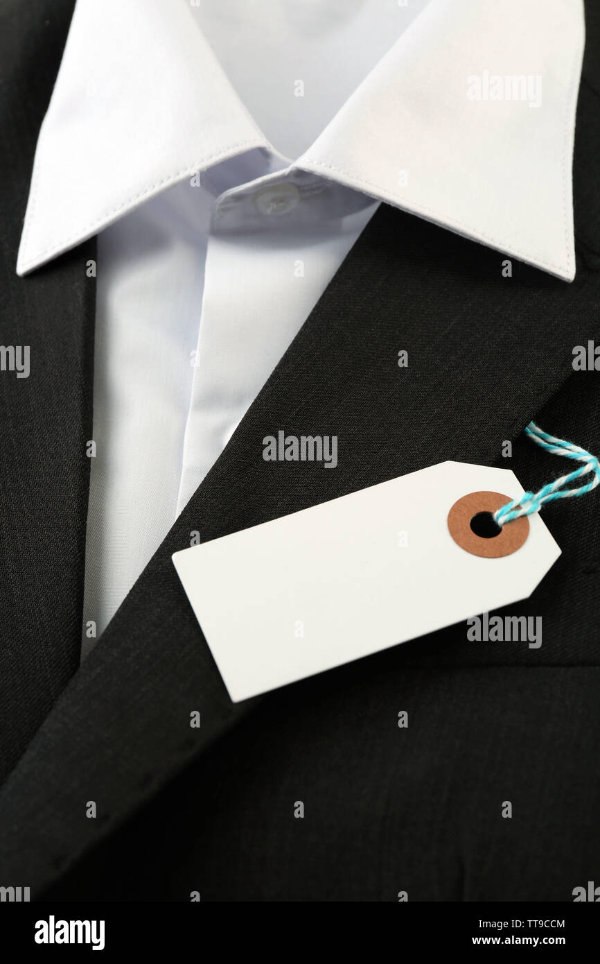 Price tag on white shirt and black jacket, close-up Stock Photo - Alamy