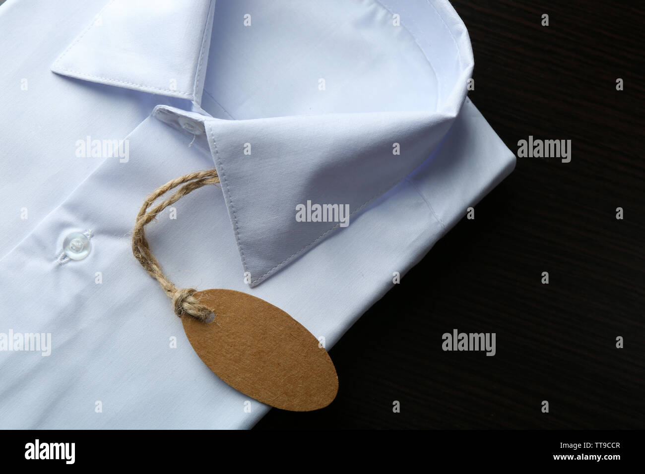 Price tag on white shirt, close-up Stock Photo - Alamy