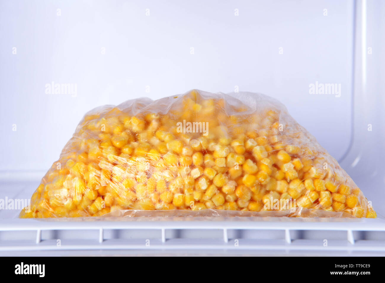 Frozen corn in bag in freezer close up Stock Photo - Alamy