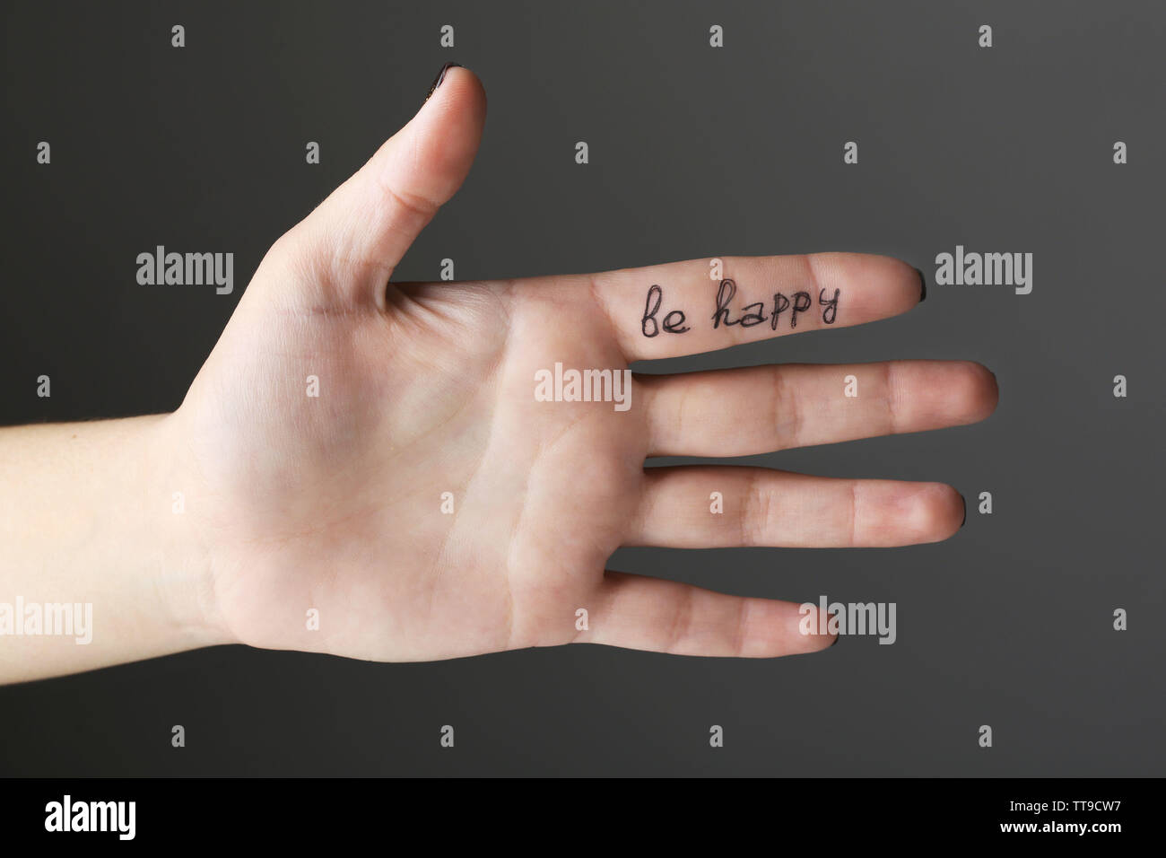 Female hand with written message on gray background Stock Photo - Alamy